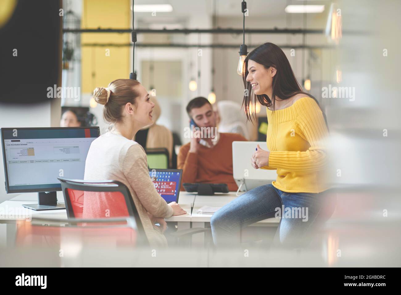 office rumors with two girls whispering in coworking open space startup ...