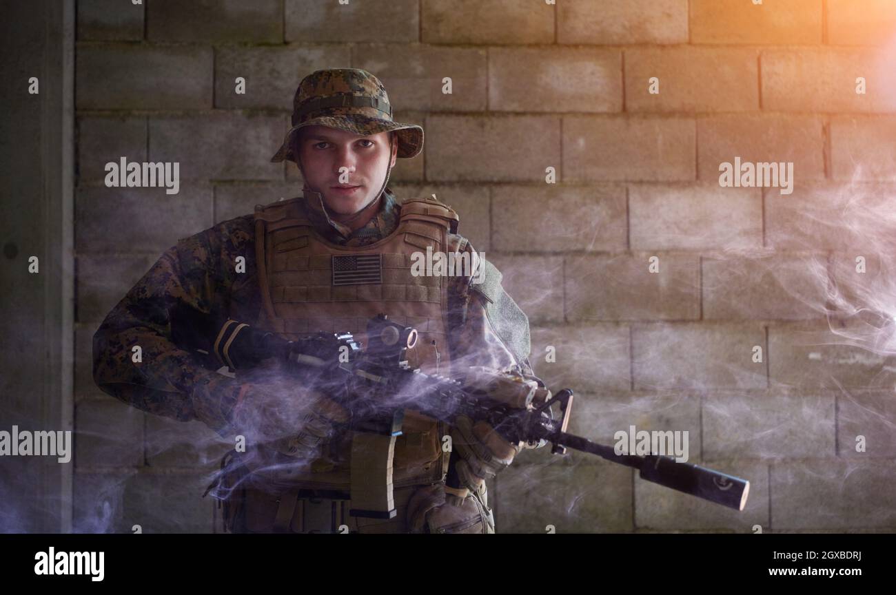 modern warfare soldier in action aiming on laser sight optics in combat ...