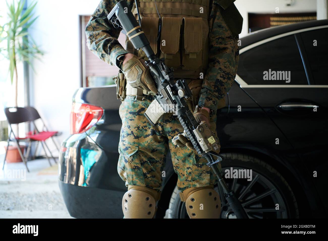 soldier protecting armored luxury vehicle a security guard in military ...
