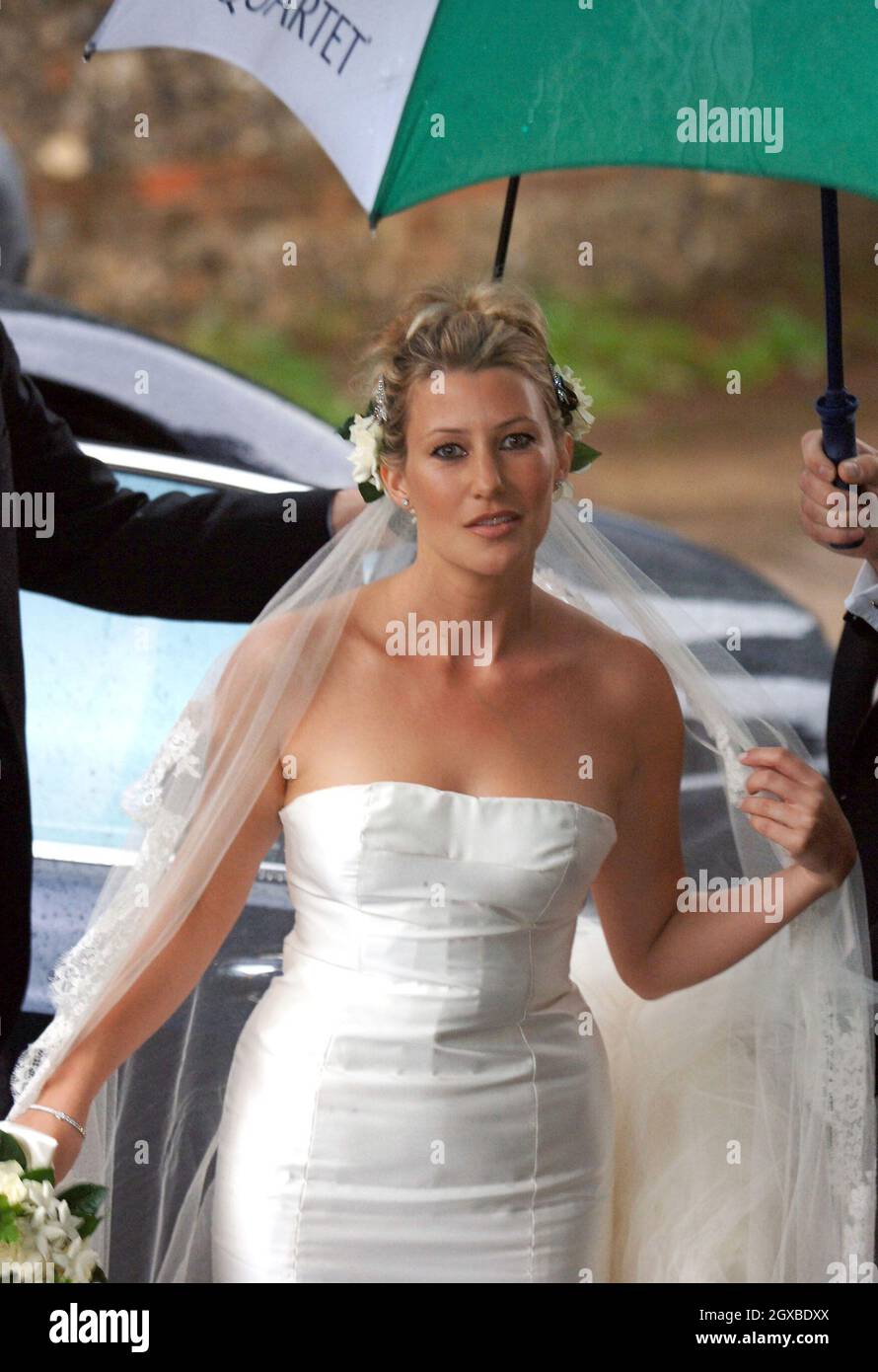 Sara Buys shelters under an umbrella as she arrives for her wedding to ...