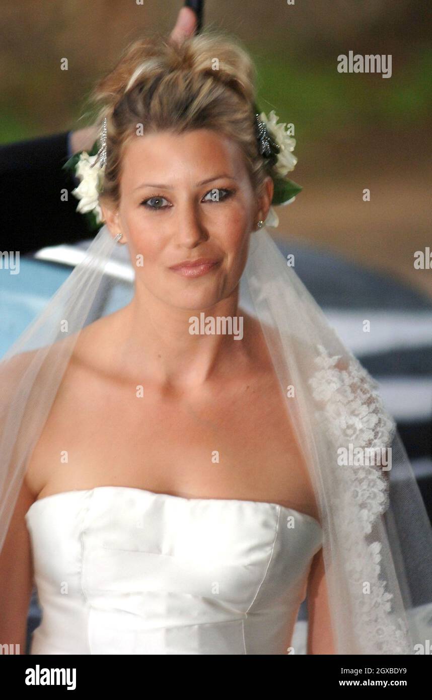 Sara Buys shelters under an umbrella as she arrives for her wedding to ...