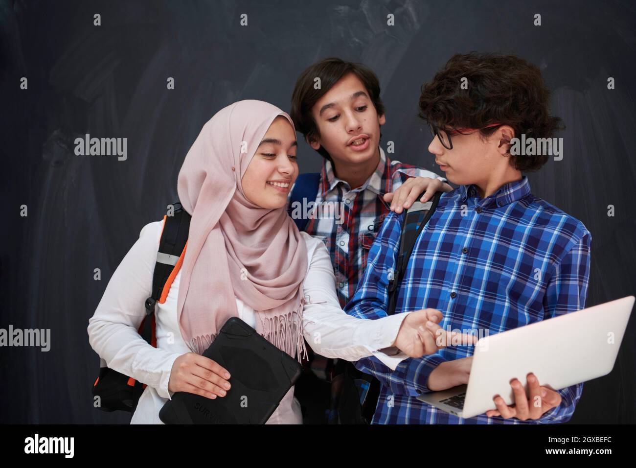 Arabic teenagers team, students group working together on laptop and ...