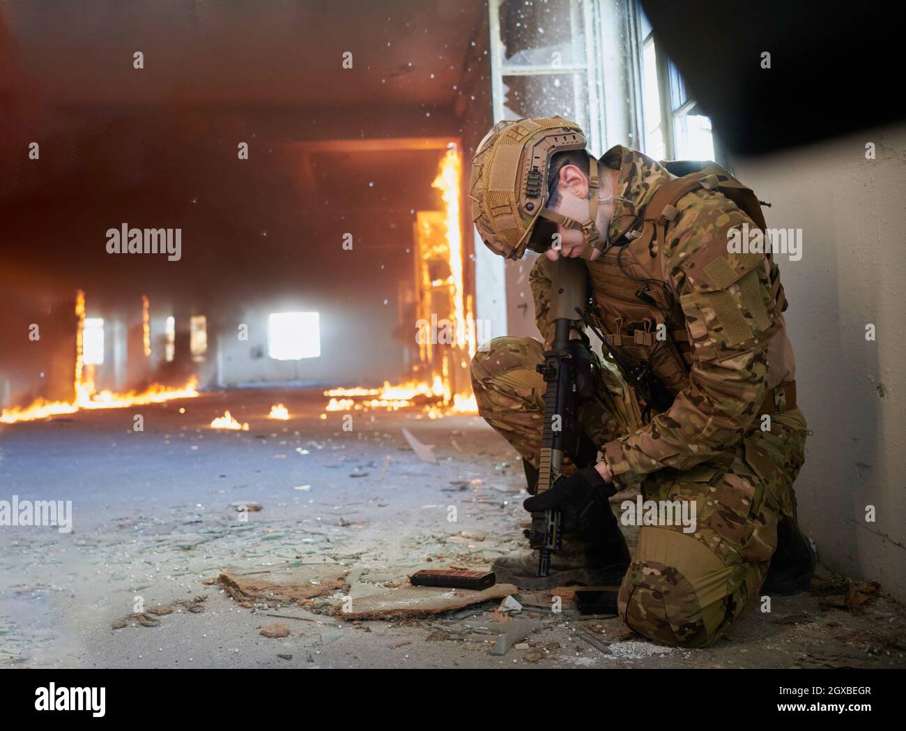 modern warfare soldier in action near window changing magazine and take ...