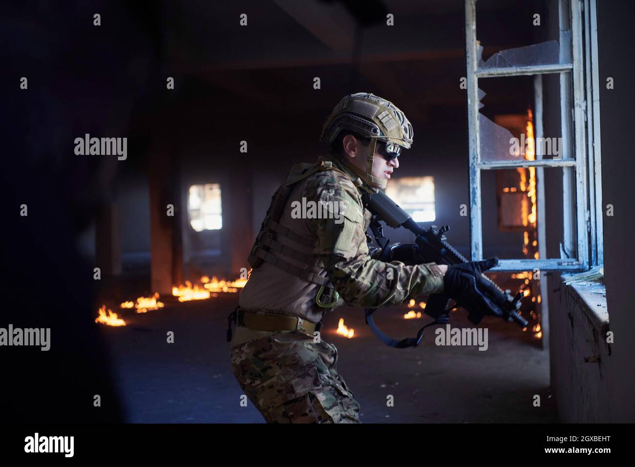 modern warfare soldier in action near window changing magazine and take ...