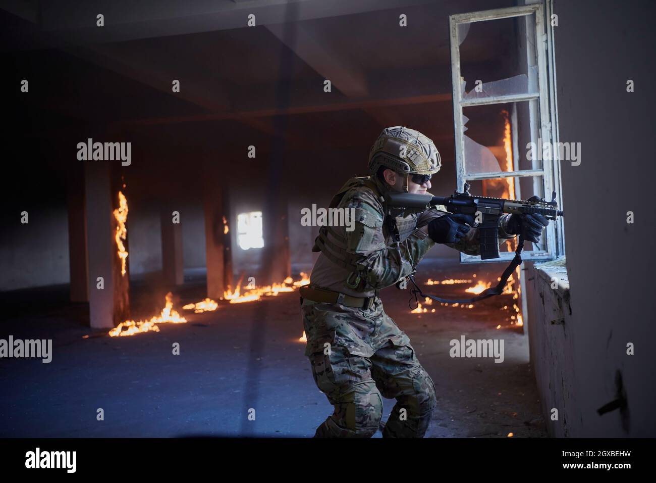 modern warfare soldier in action near window changing magazine and take ...