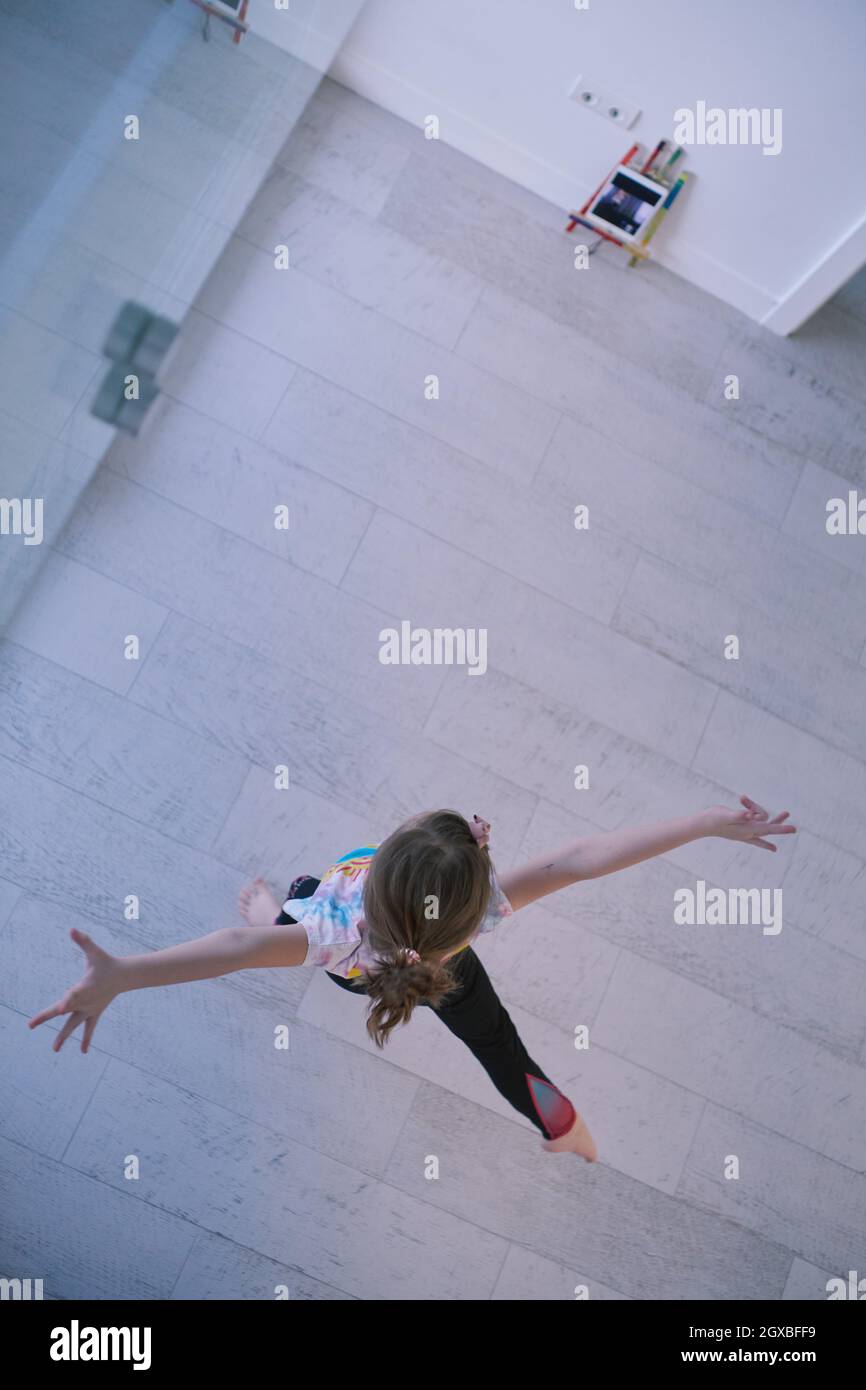 Little girl have online training over tablet and doing modern ballet ...