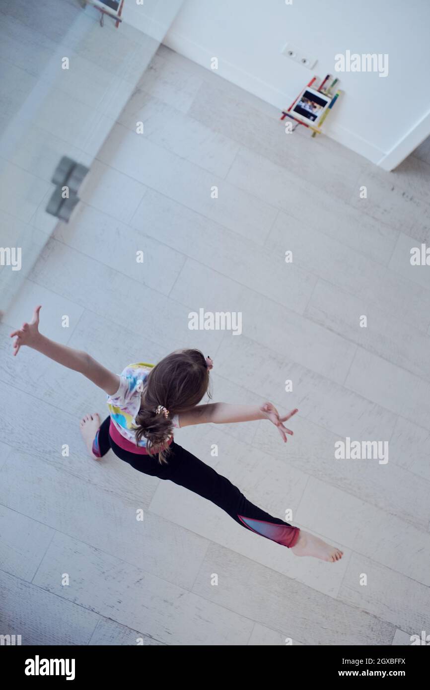 Little girl have online training over tablet and doing modern ballet ...