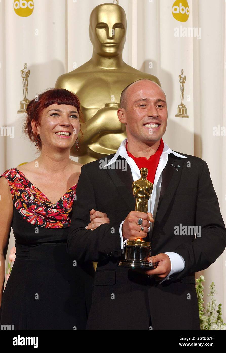 Adam Elliott and Melanie Coombs poses backstage at the 76th Annual ...