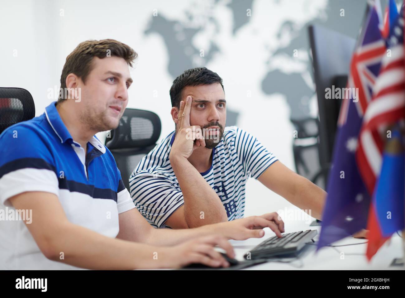 startup business, two male software developers working on computer at ...