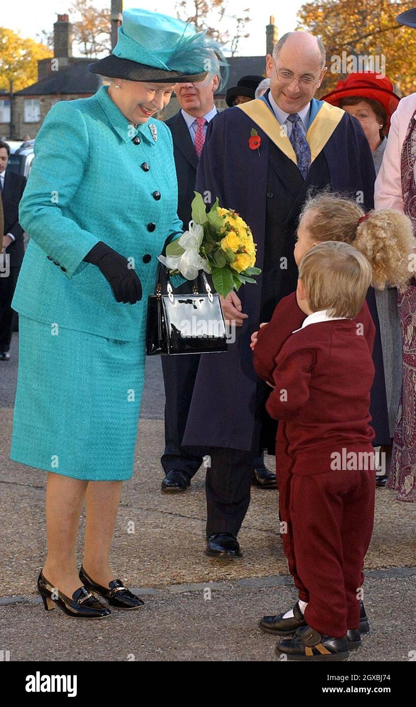 Britain's Queen Elizabeth II meets children wearing their tradtional ...
