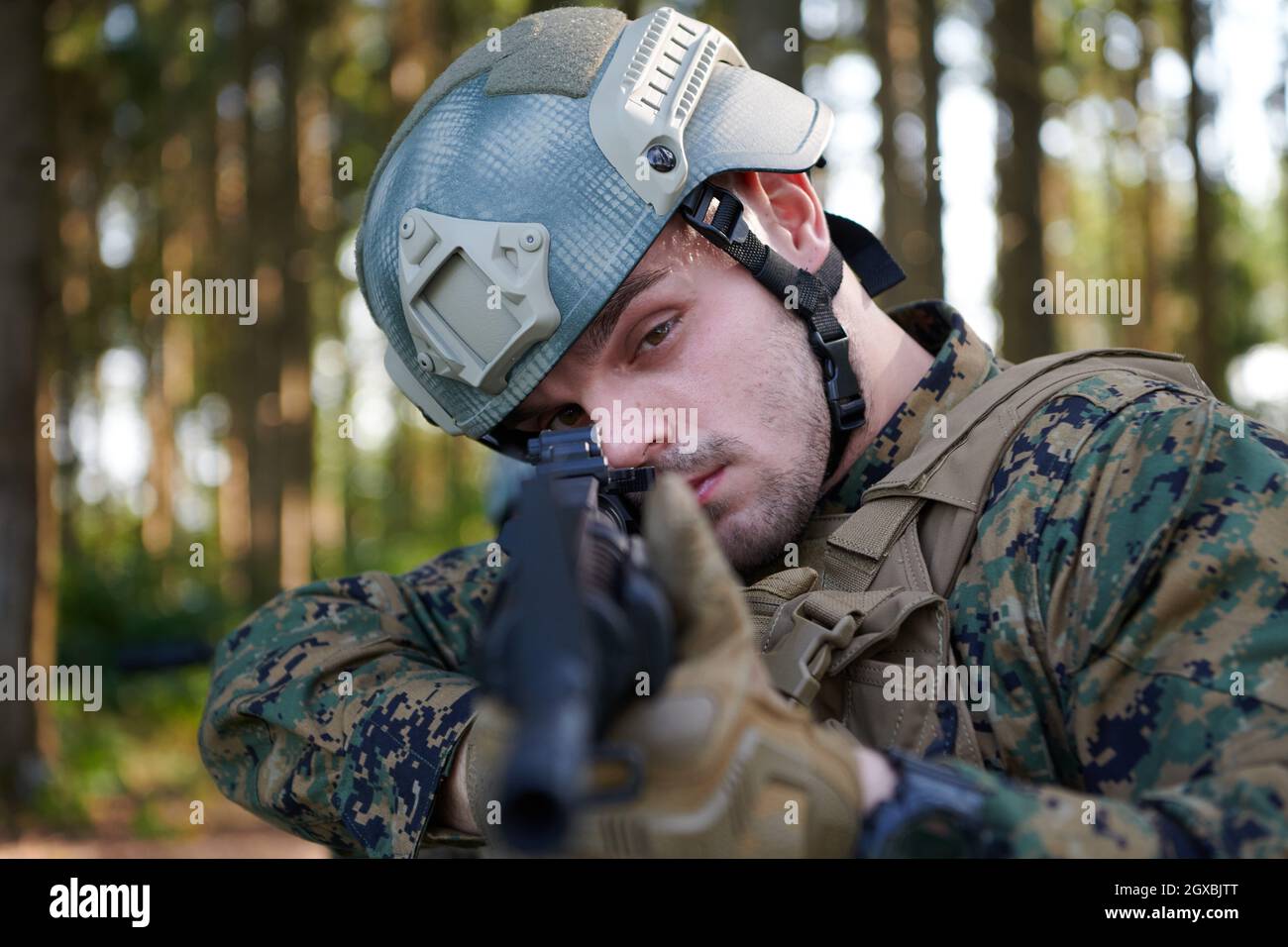 modern warfare soldier in action aiming at weapon laser sight optics in ...