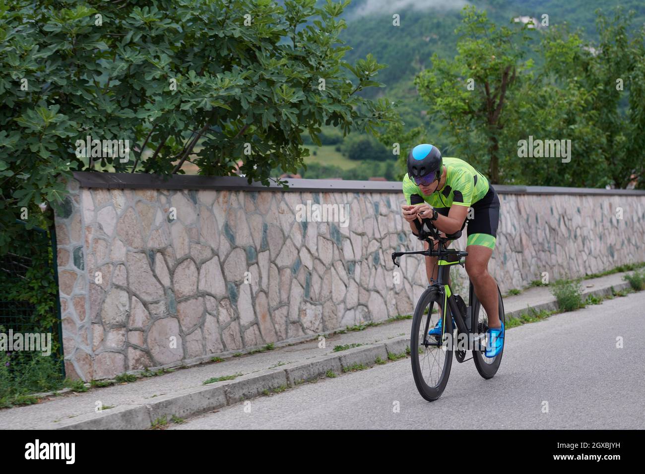 triathlon athlete riding racing bike on morning training urban enviroment Stock Photo - Alamy