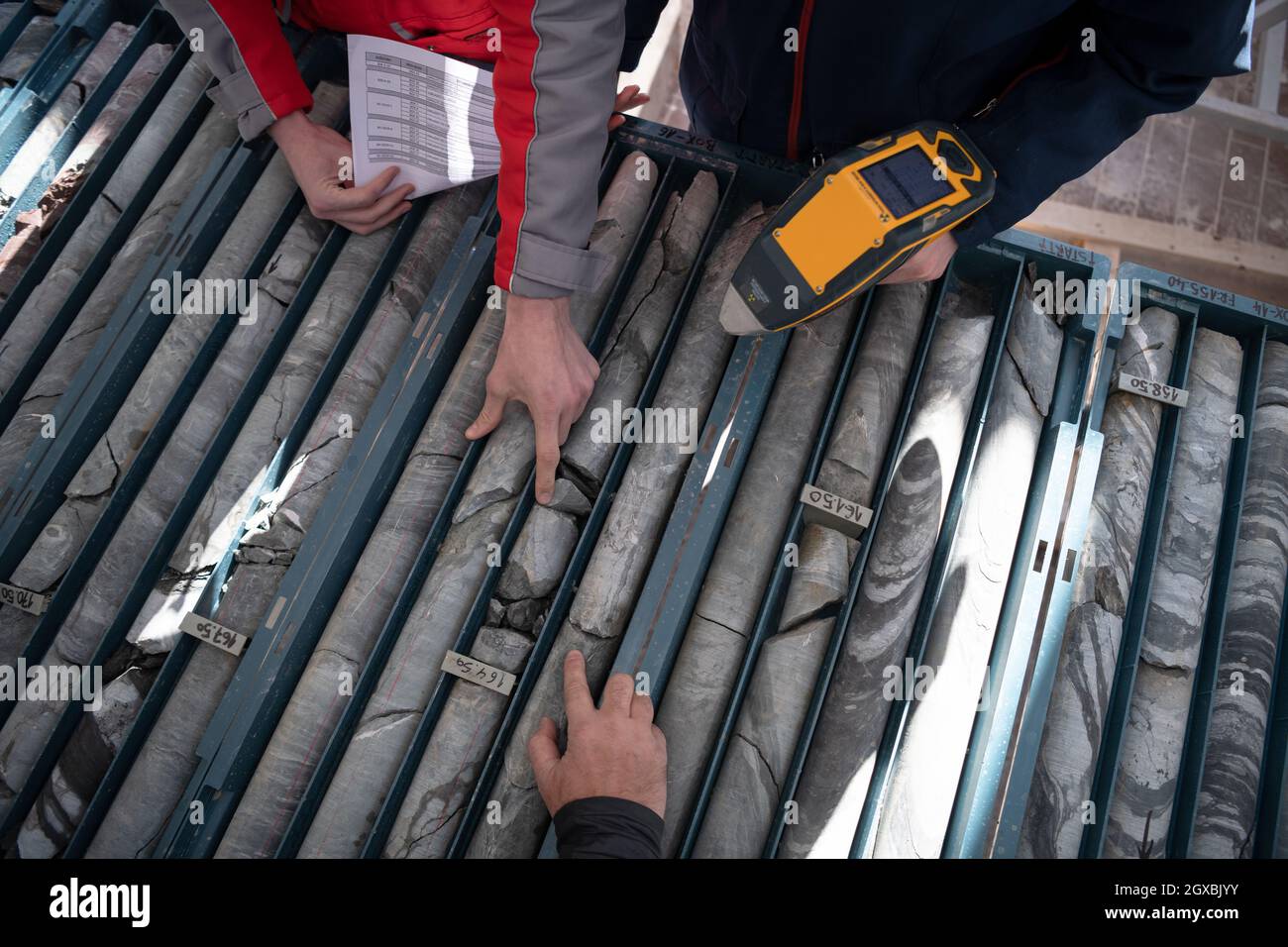 geological gold core samples with team of mining workers measuring ...