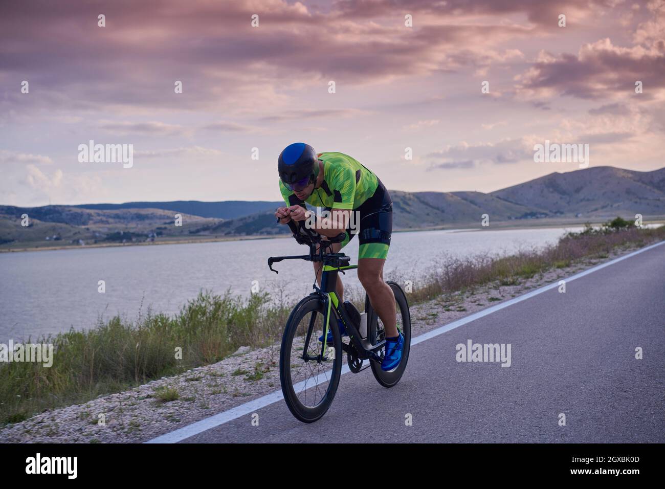 triathlon athlete riding professional racing bike at workout on curvy country road Stock Photo ...