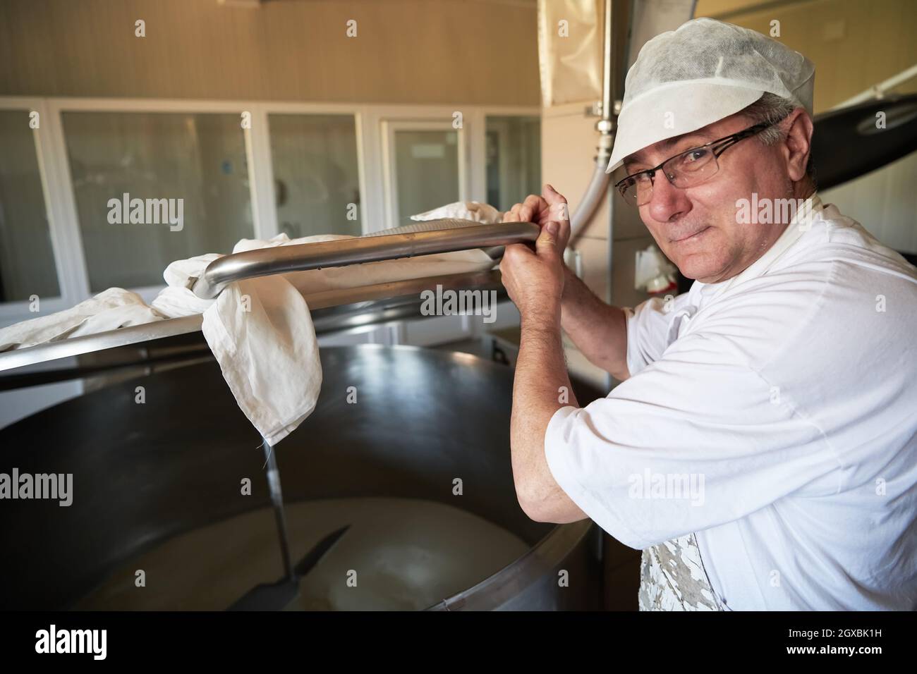 Cheese production male cheesemaker employee working in factory Stock ...