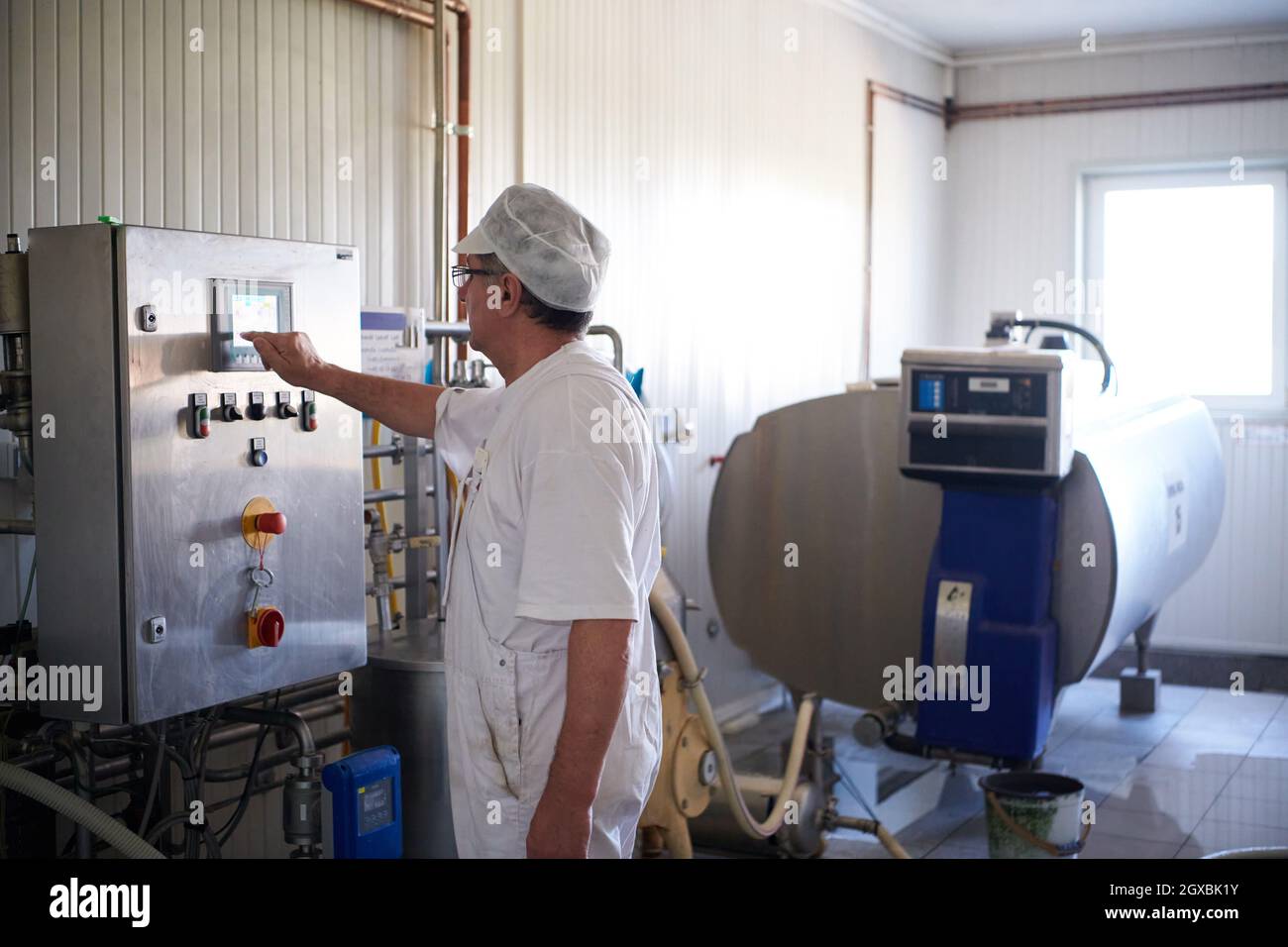 Cheese production male cheesemaker employee working in factory Stock ...