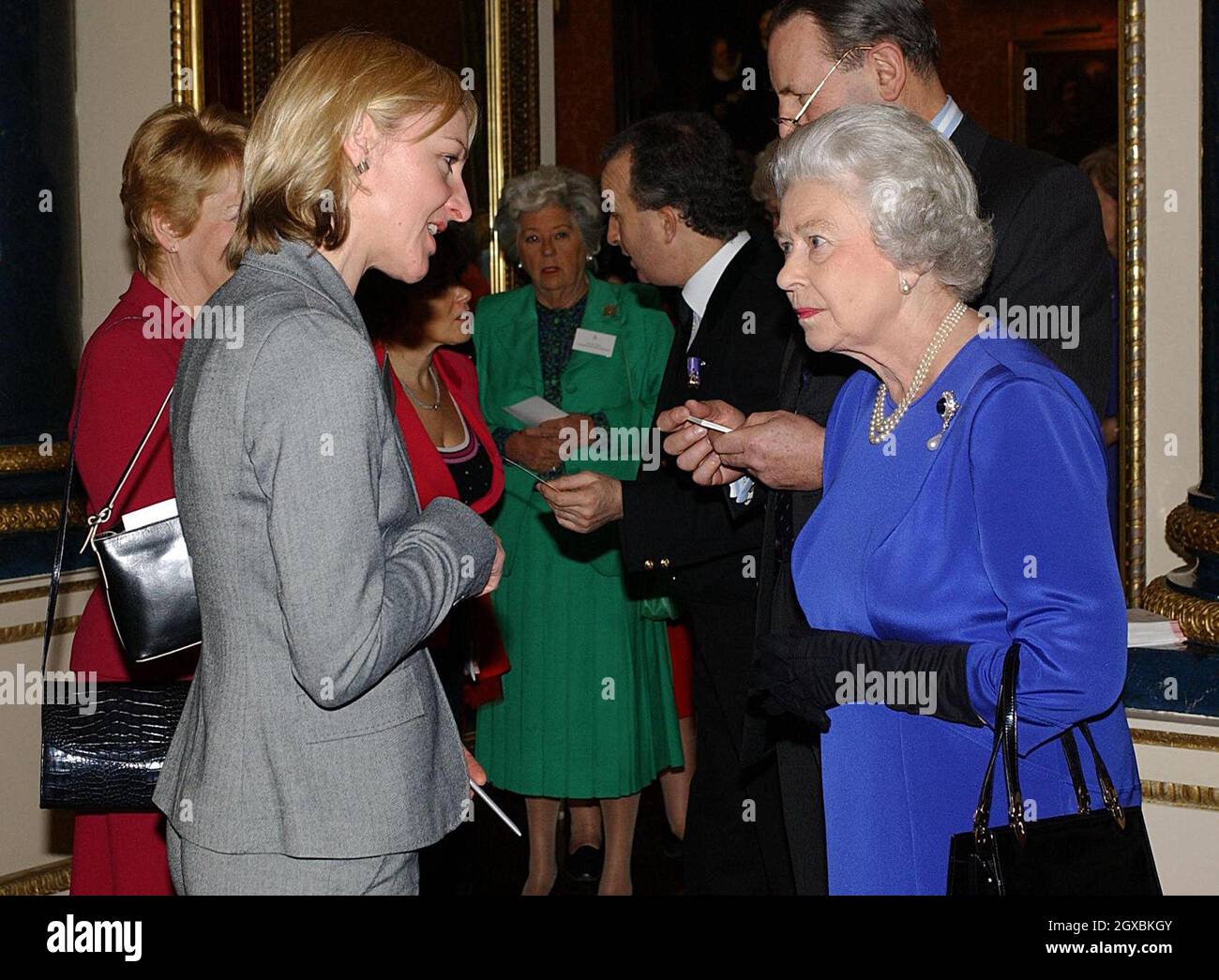 Britain's Queen Elizabeth II talks with charity campaigner Jayne Zito ...