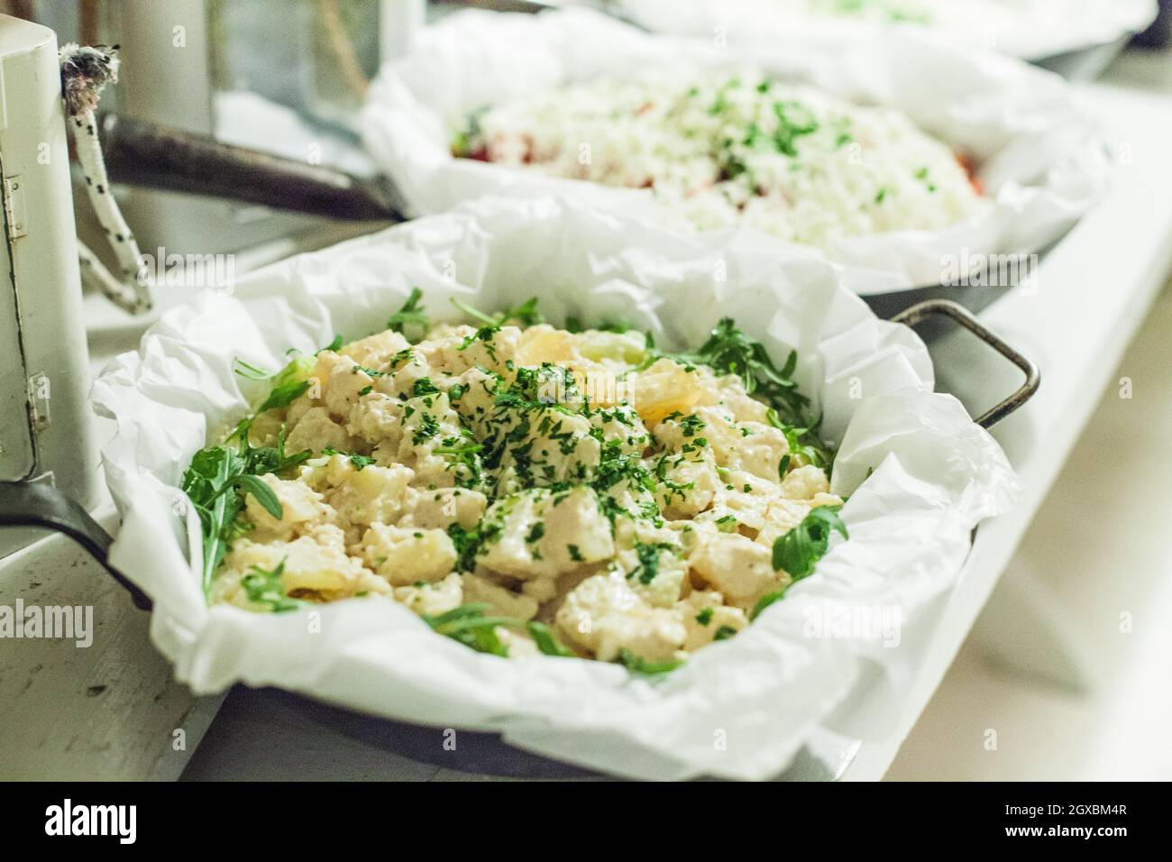 Food served catering at the party, boiled potatoes with rocket Stock ...