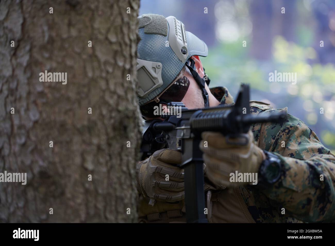 modern warfare soldier in action aiming at weapon laser sight optics in ...