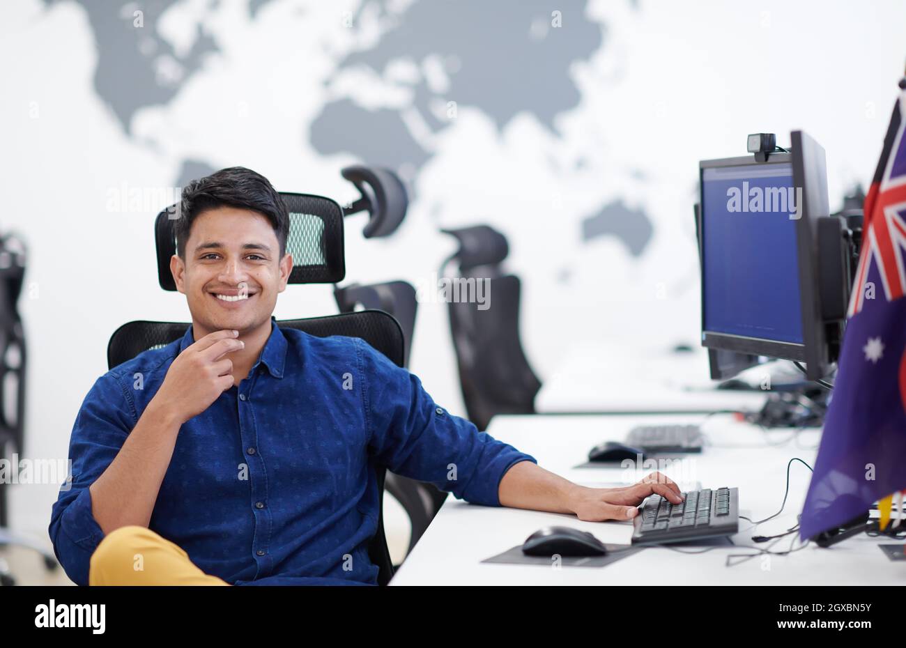 casual indian business man working on desktop computer in modern open ...