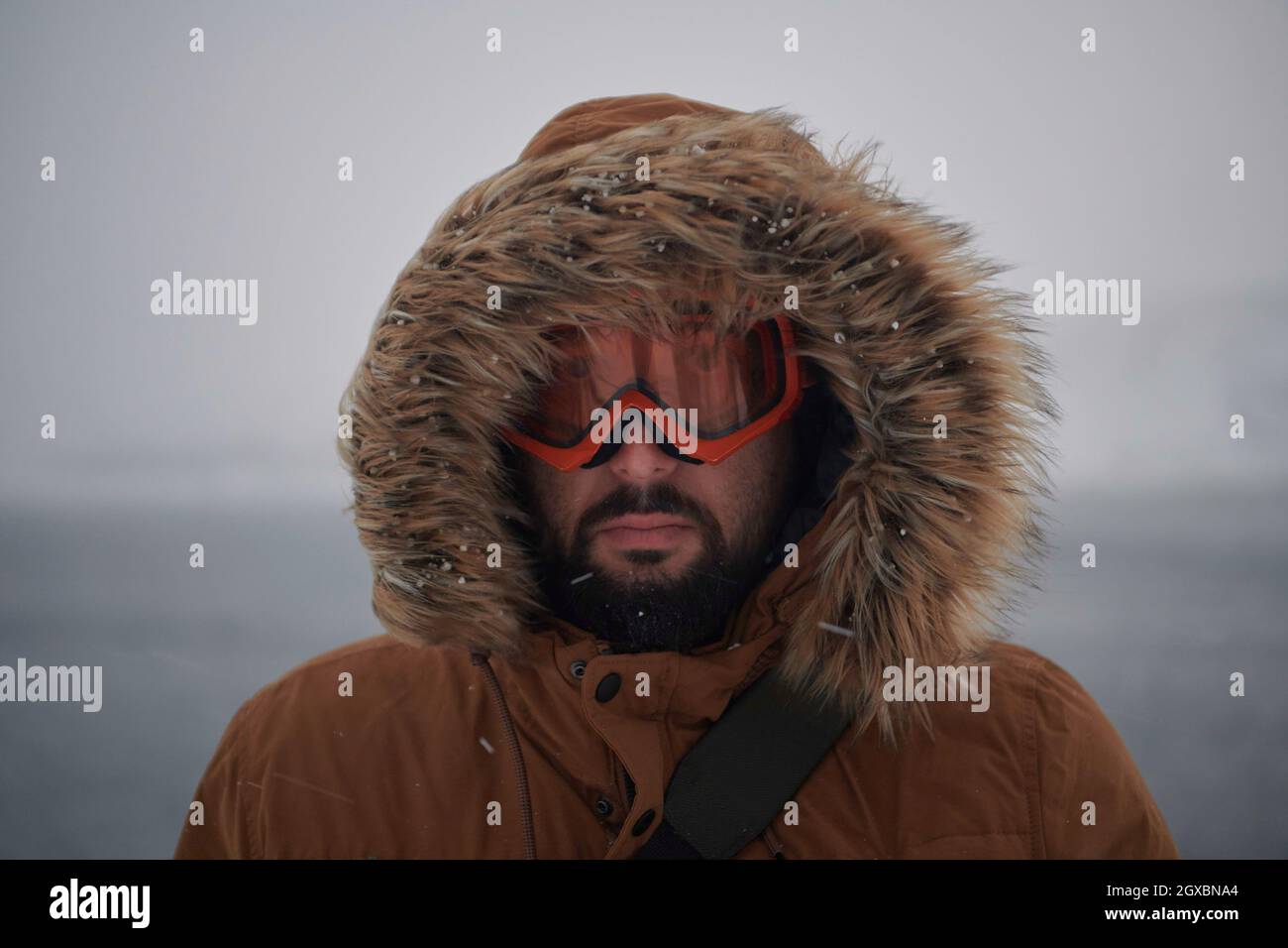 portrait local authentic eskimo man at winter in stormy weather wearing ...