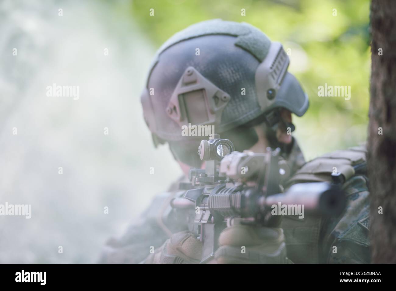 modern warfare soldier in action aiming at weapon laser sight optics in ...