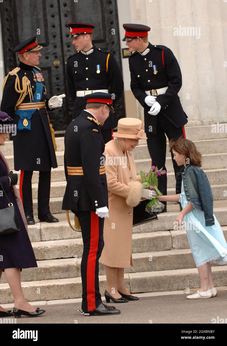 Queen Elizabeth II is presented with flowers as Prince Philip, Duke of ...