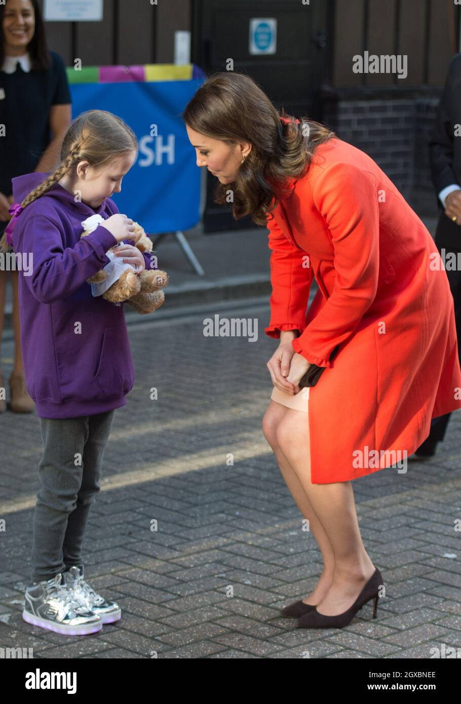 Pregnant Catherine, Duchess of Cambridge, wearing a red Boden coat, is ...