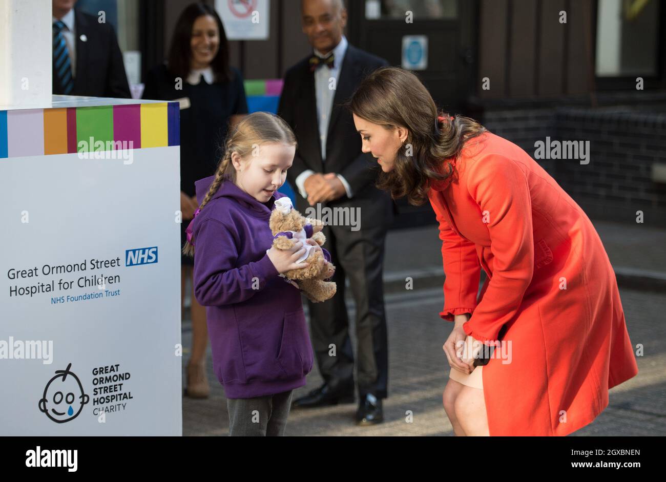 Pregnant Catherine, Duchess of Cambridge, wearing a red Boden coat, is ...