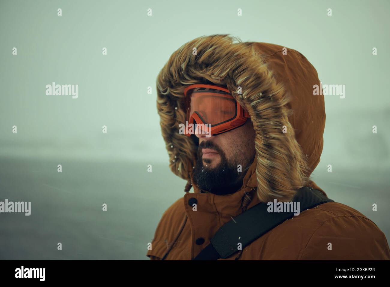 portrait local authentic eskimo man at winter in stormy weather wearing ...