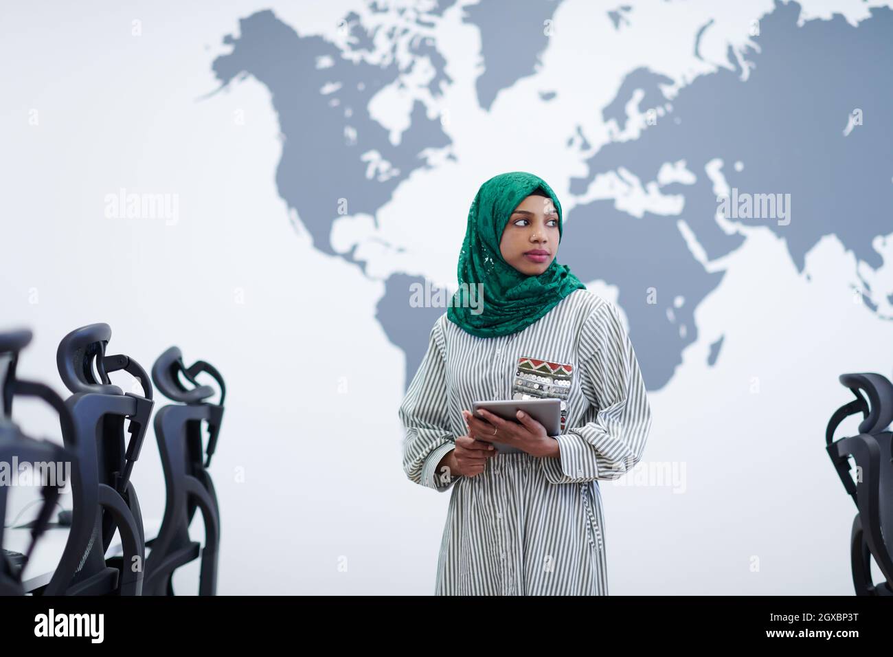 Portrait of muslim african female software developer with green hijab ...
