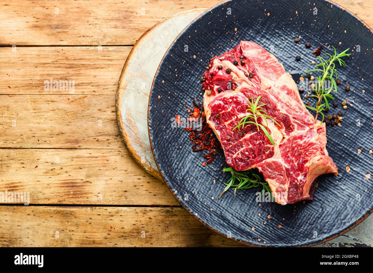 Raw beef meat with rosemary and spices.Uncooked beef steak Stock Photo ...
