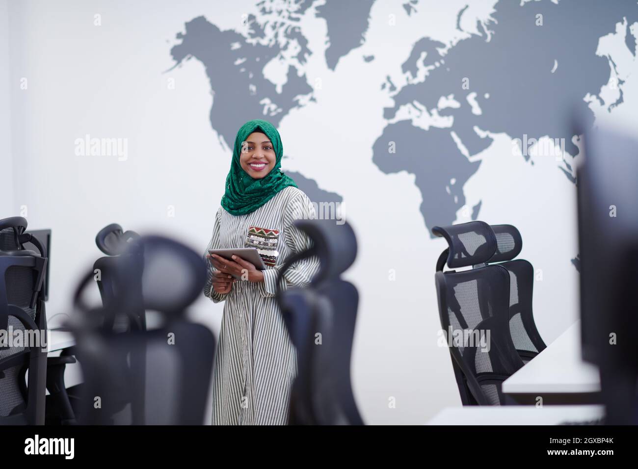 Portrait of muslim african female software developer with green hijab ...