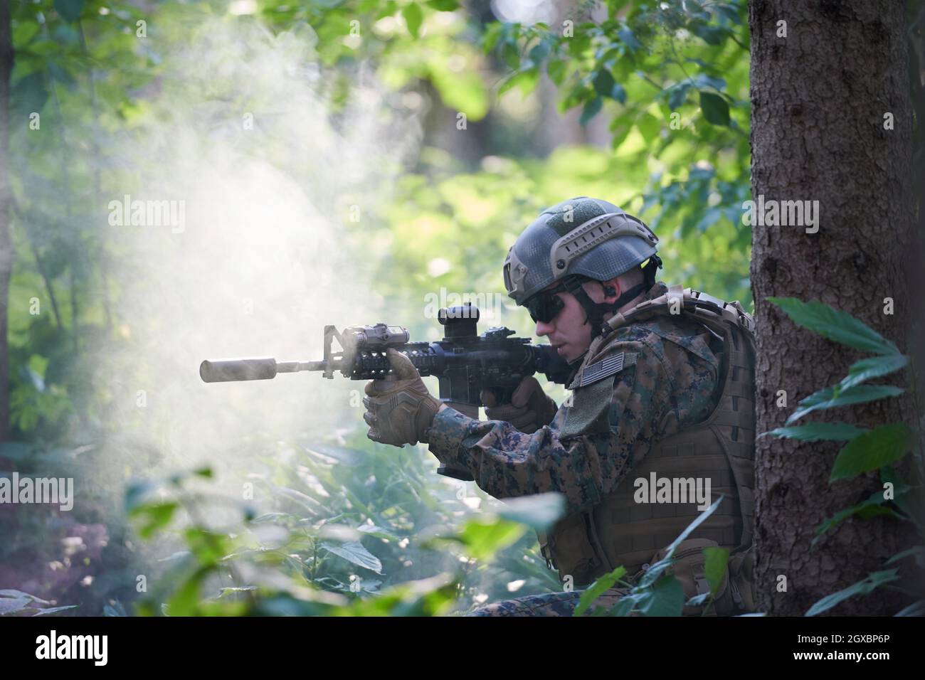 modern warfare soldier in action aiming at weapon laser sight optics in ...
