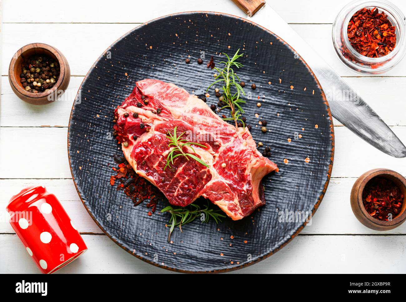 Raw beef meat with rosemary and spices Stock Photo - Alamy