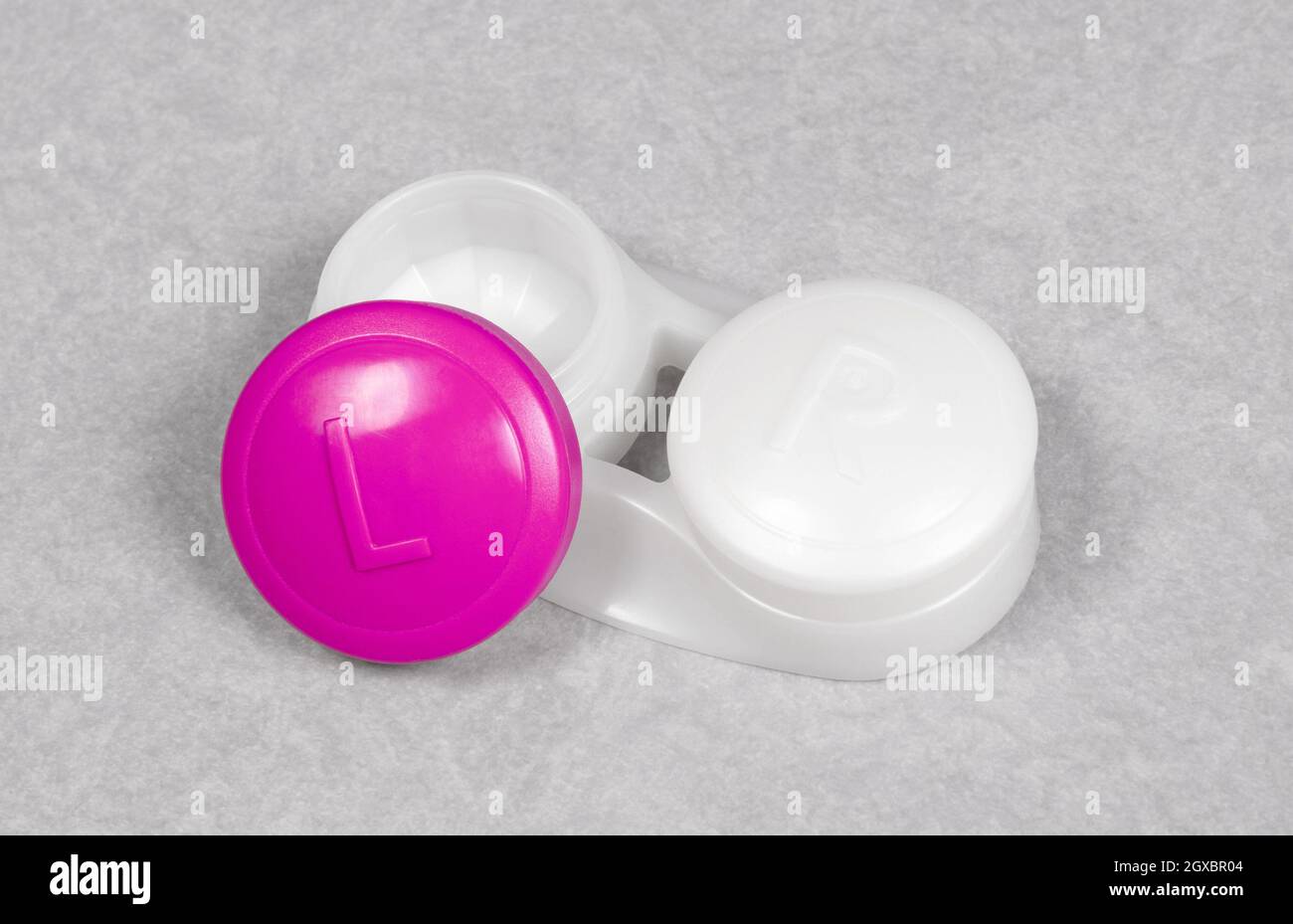 Pink contact lens case, isolated on grey background Stock Photo - Alamy