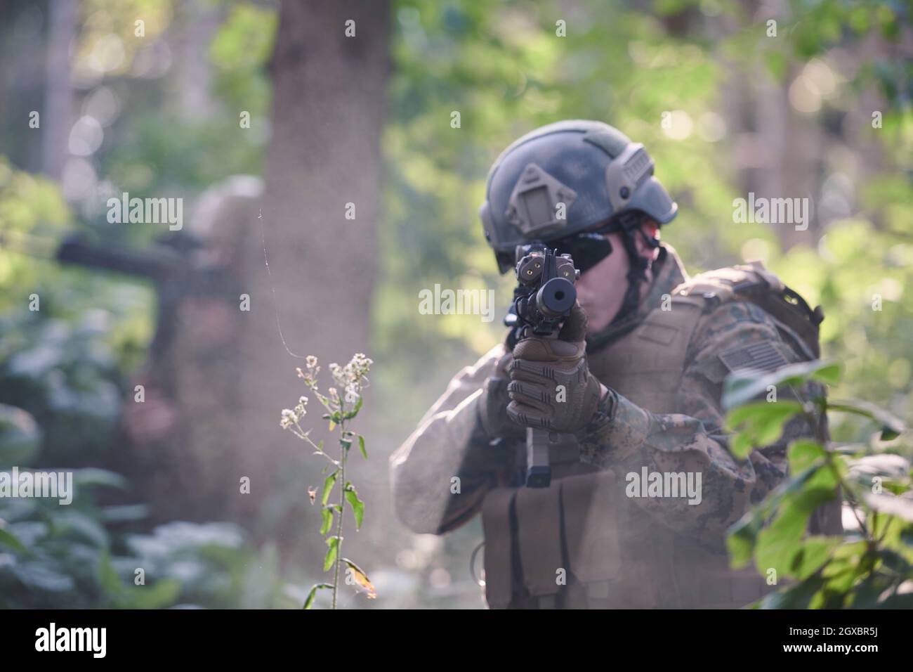 modern warfare soldier in action aiming at weapon laser sight optics in ...