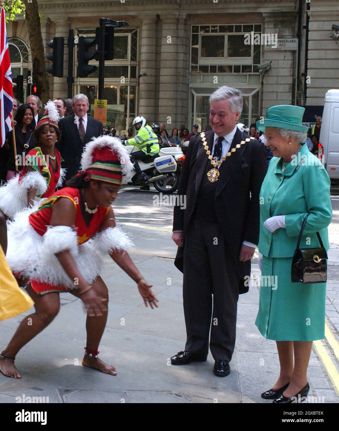 Queen Elizabeth II is greeted by Commonwealth dancers as she arrives ...