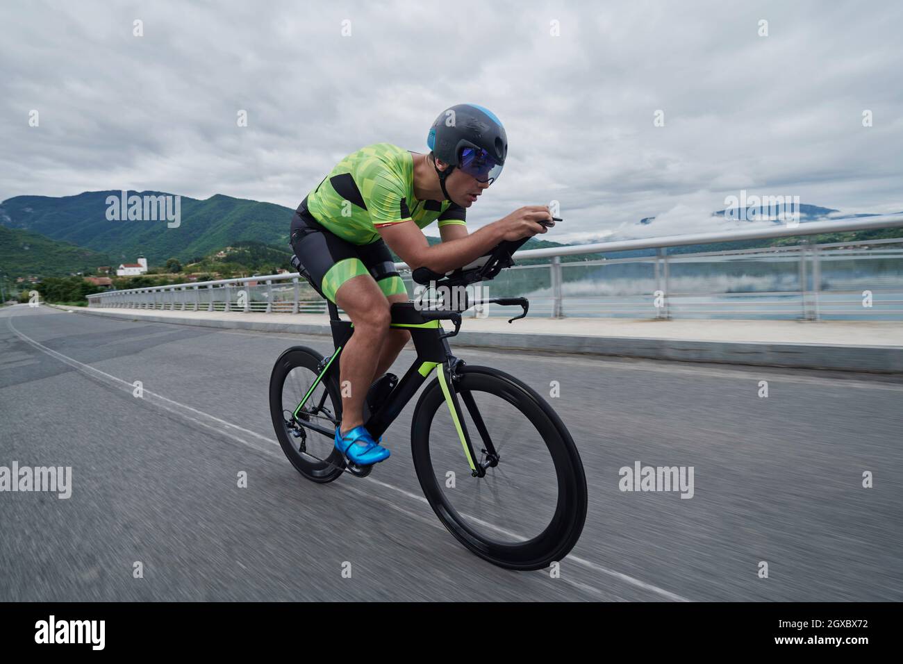 triathlon athlete riding racing bike on morning training urban ...