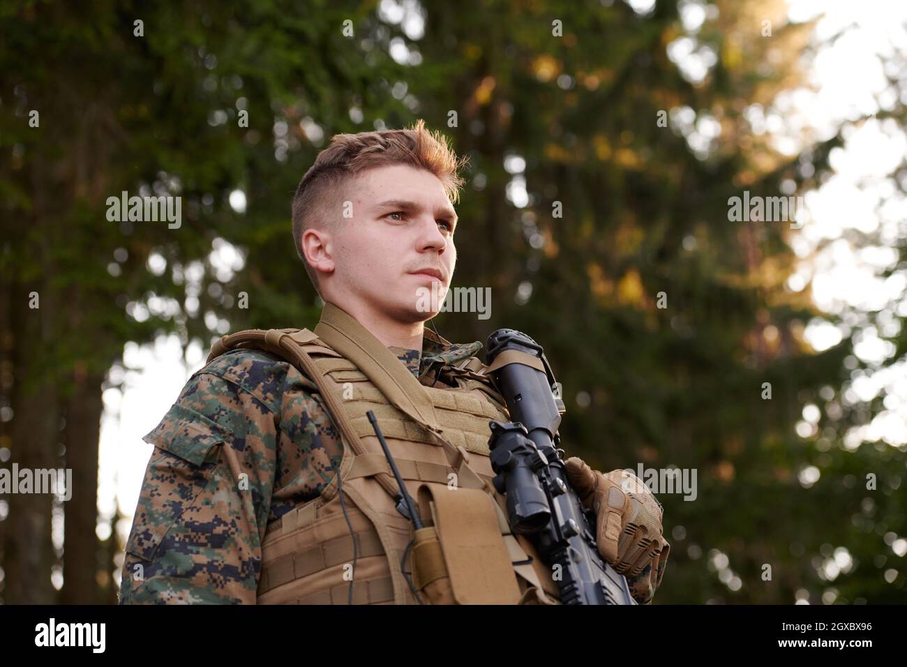 soldier portrait with protective army tactical gear against old brick ...