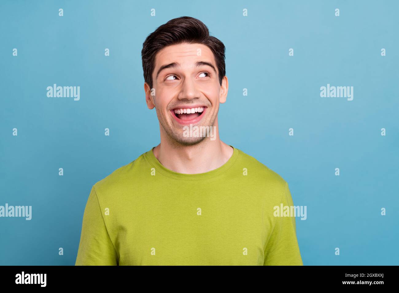 Photo of dreamy sweet young man wear green t-shirt smiling looking ...