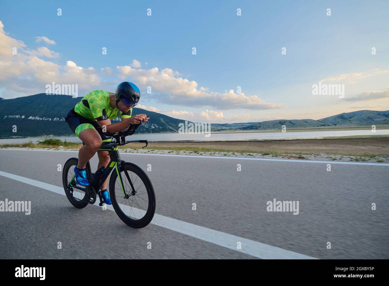 triathlon athlete riding professional racing bike at workout on curvy country road Stock Photo ...