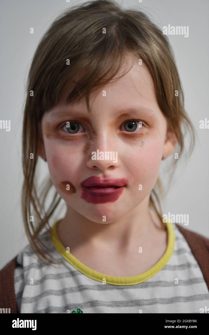 Cute little preschool girl playing with mommy's make up. Fashion ...