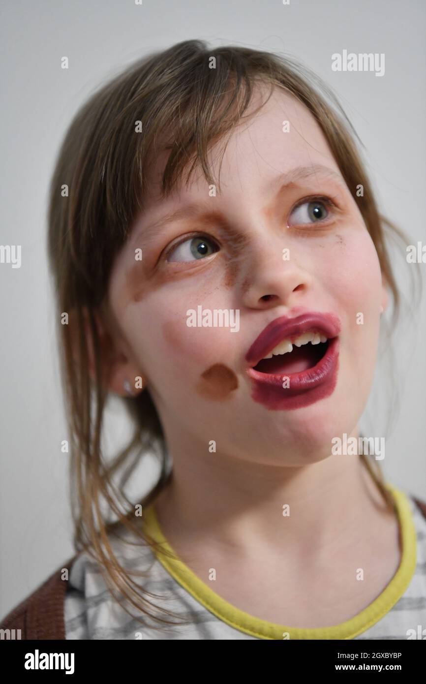 Cute little preschool girl playing with mommy's make up. Fashion ...