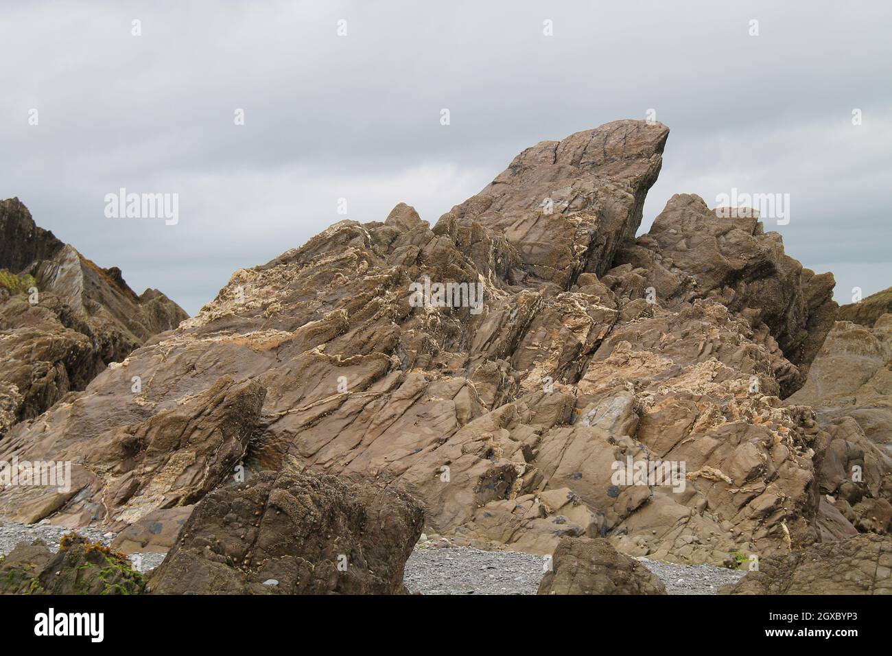 A Dramatic Rocky Outcrop on a Coastal Beach Stock Photo - Alamy