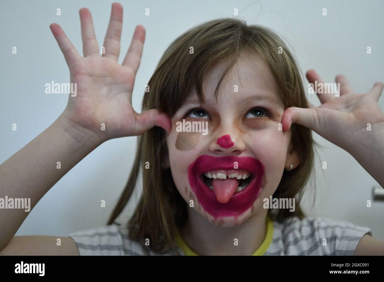 Cute little preschool girl playing with mommy's make up. Fashion ...