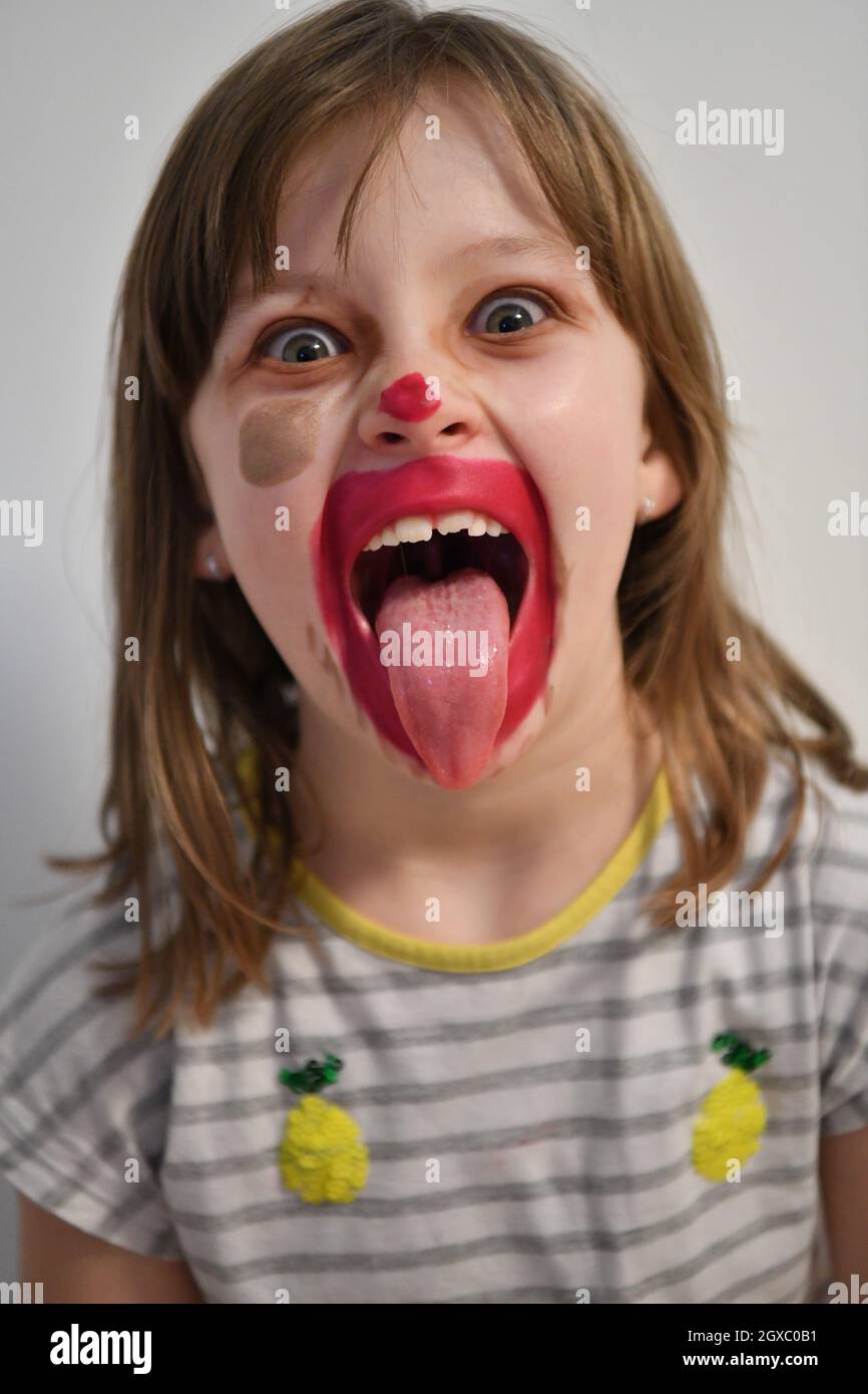 Cute little preschool girl playing with mommy's make up. Fashion ...