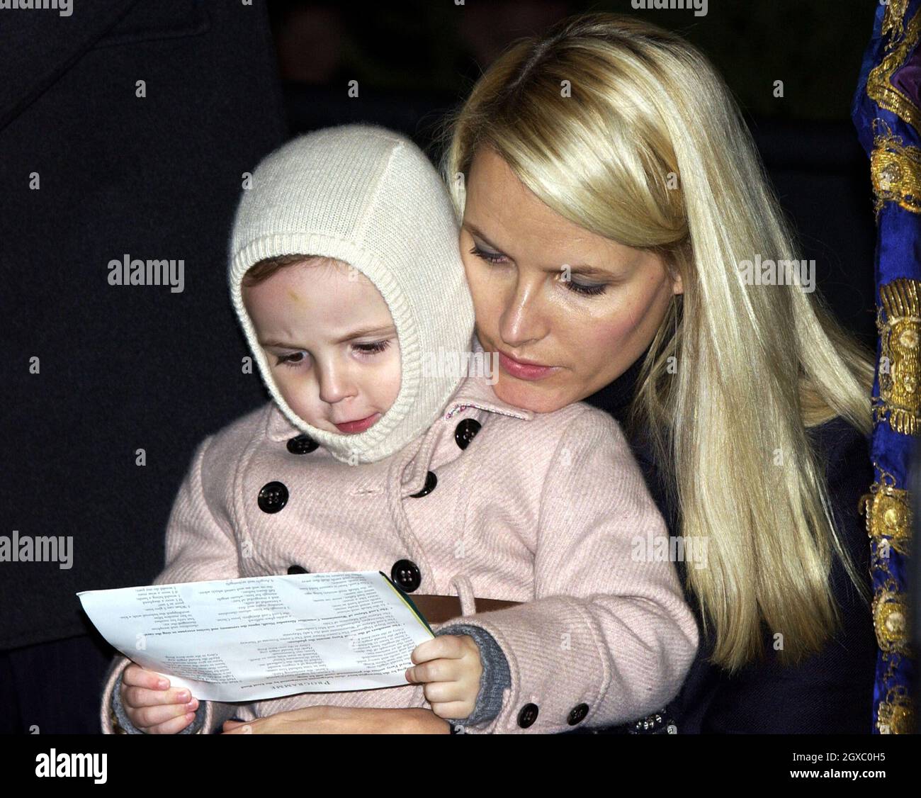 Crown Princess Mette-Marit of Norway bends to hold daughter, Princess ...