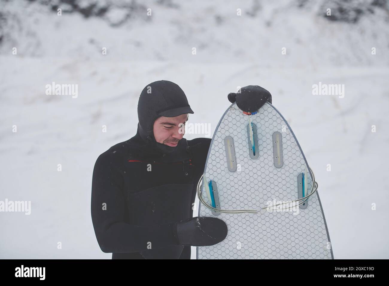 Authentic local Arctic surfer portrait holding a board after surfing in ...