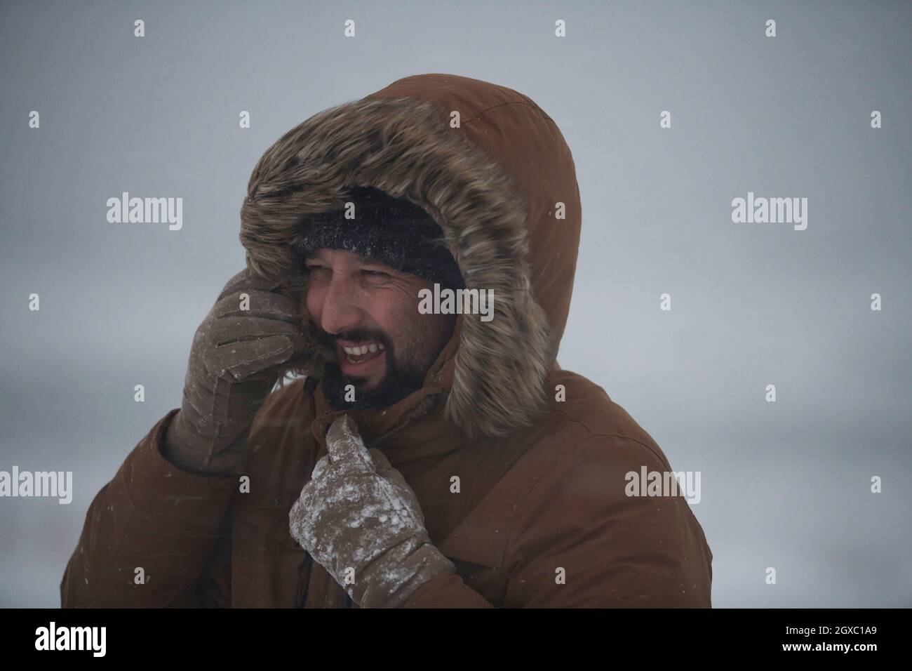 portrait local authentic eskimo man at winter in stormy weather wearing ...